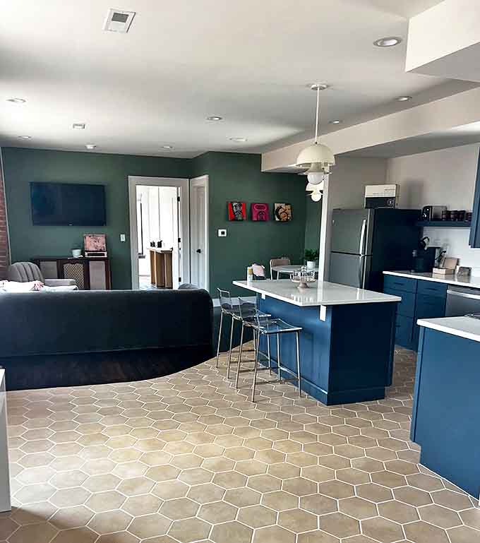 Deep blue cabinetry and open-concept design create a spacious modern retreat that would make any apartment dweller jealous of these overnight accommodations.