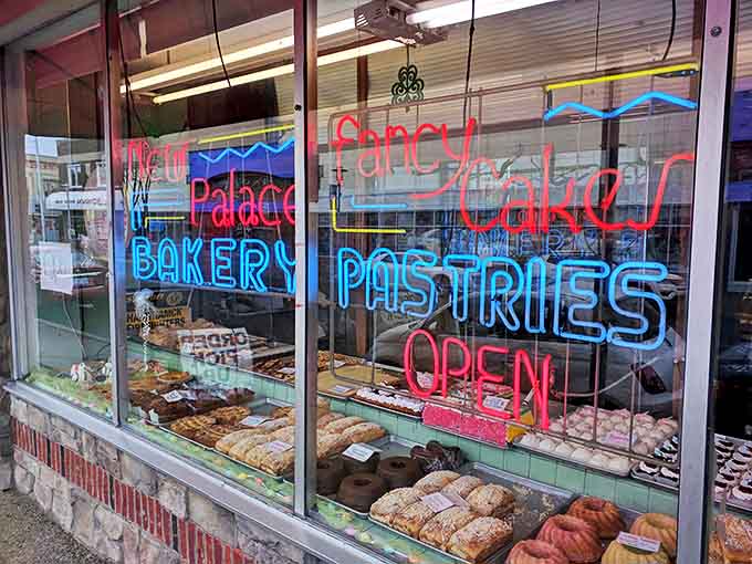 The neon-lit window display serves as a beacon of baked hope in Hamtramck, promising sweet salvation to all who enter.