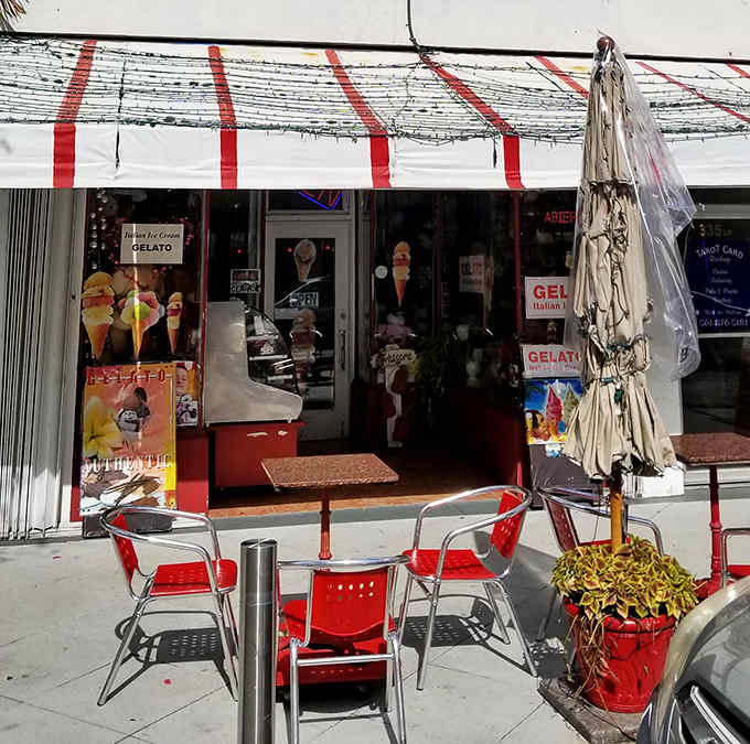 Red chairs and tables create a perfect perch for gelato appreciation, where Florida sunshine ensures your treats melt at precisely the right pace.