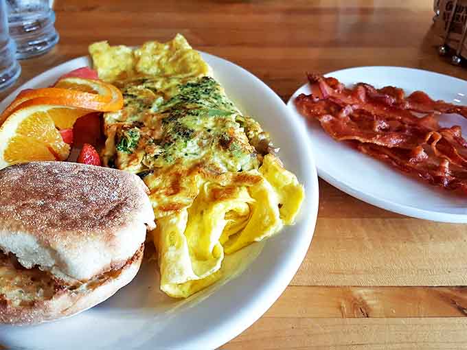 Omelet Breakfast: Morning glory on a plate &ndash; a fluffy omelet alongside crispy bacon, fresh fruit, and an English muffin makes breakfast the most important meal.