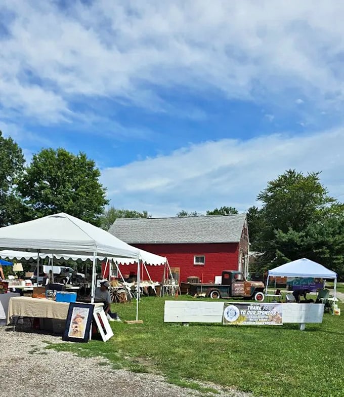 The outdoor market setup with tents and vintage trucks creates a festive atmosphere that makes antique shopping feel like a treasure hunt at a really cool county fair.