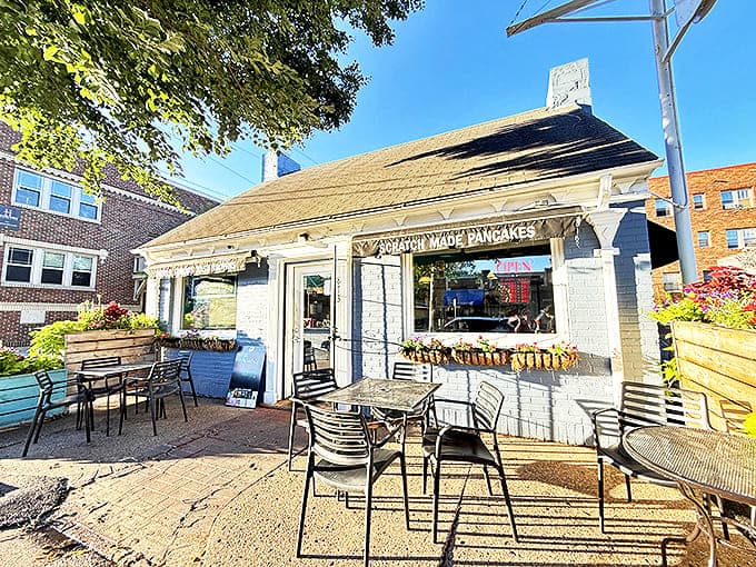 Urban breakfast oasis &ndash; simple wooden tables surrounded by hanging flower baskets create the perfect spot for al fresco morning dining.