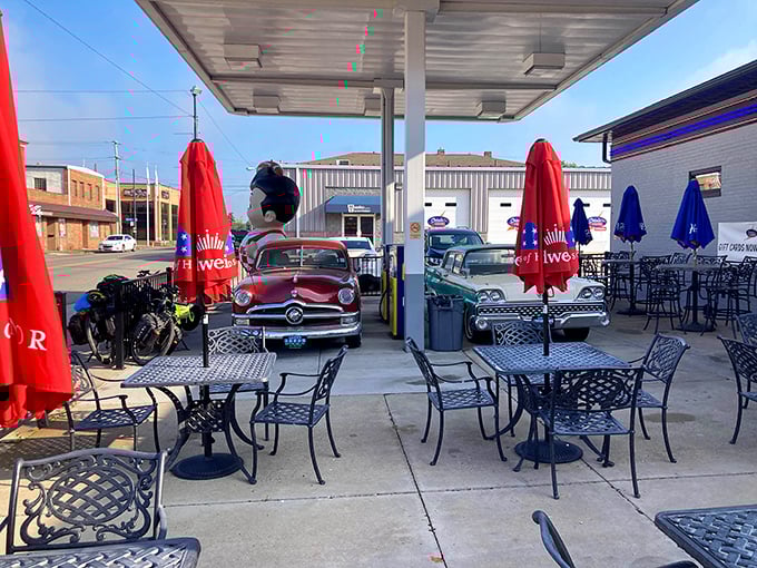 Outdoor dining with a vintage twist &ndash; classic cars and gas station vibes create the perfect backdrop for your burger experience.