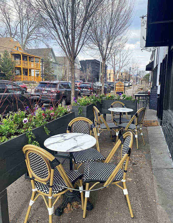 The outdoor seating area transforms an ordinary sidewalk into a little slice of European caf&eacute; culture, complete with those classic bistro chairs.