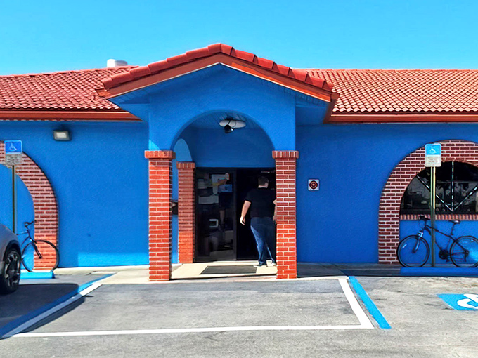 A welcoming entrance that promises authentic Greek cuisine – the blue archway is your portal to Mediterranean flavors.