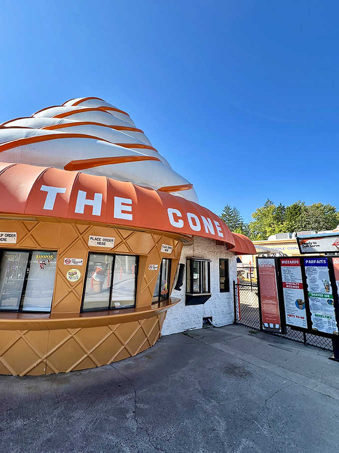 The distinctive cone-shaped building stands as a beloved local landmark, its whimsical architecture promising sweet adventures inside.