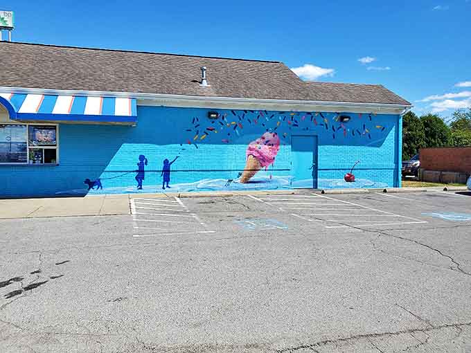 The blue wall mural transforms an ordinary lot into an ice cream wonderland, where even waiting in line becomes part of the experience.