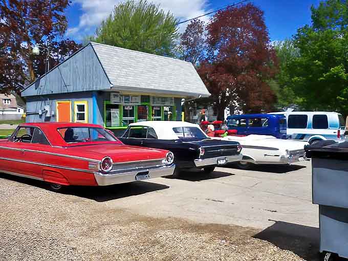 A rainbow of vintage automobiles lines up outside Ginny's, their chrome gleaming like the memories being made over malts and burgers.