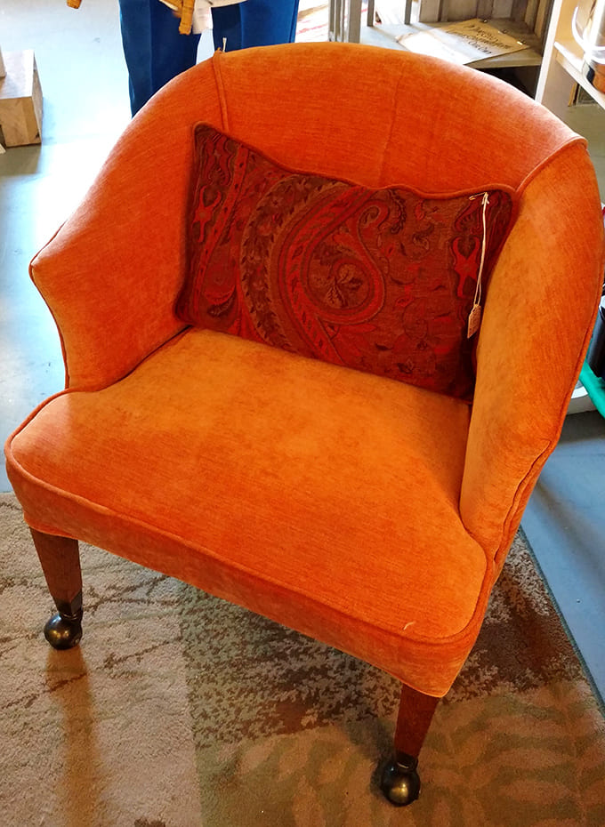 This orange velvet armchair has more personality than most people's entire living rooms, and it knows it too.