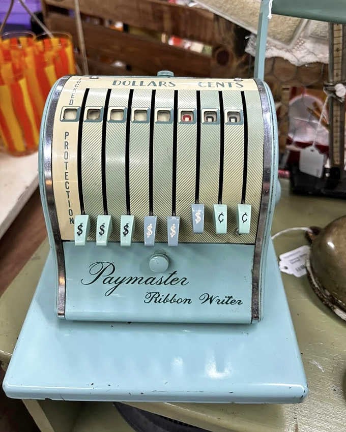 The Paymaster Ribbon Writer sits ready to calculate payroll the old-fashioned way, back when office equipment doubled as workout equipment.