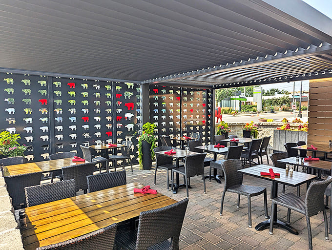 The outdoor patio features playful cow silhouettes against a dark backdrop &ndash; al fresco dining with a side of whimsy.