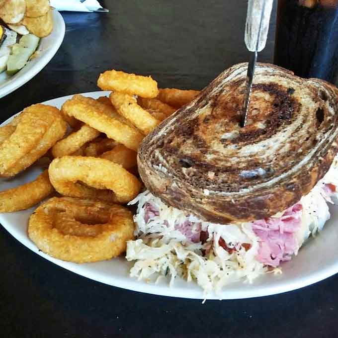 The Reuben sandwich towers with corned beef and sauerkraut between marble rye &ndash; a two-handed affair worth every delicious bite.