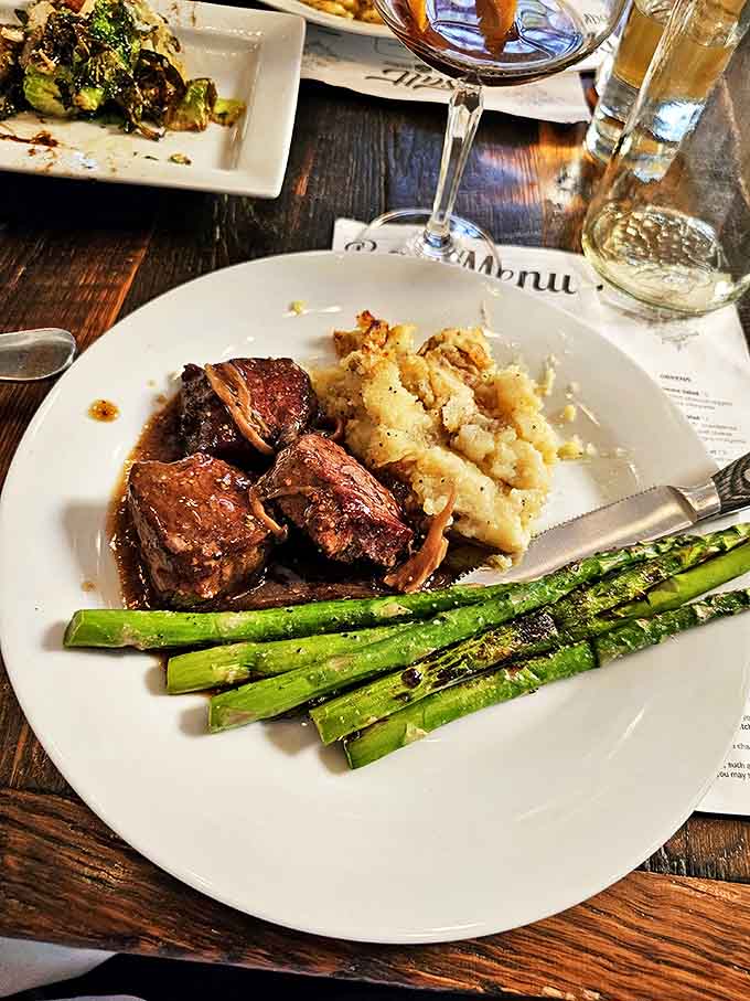 Perfectly cooked beef alongside creamy mashed potatoes and vibrant asparagus – a holy trinity of flavor on a single plate.