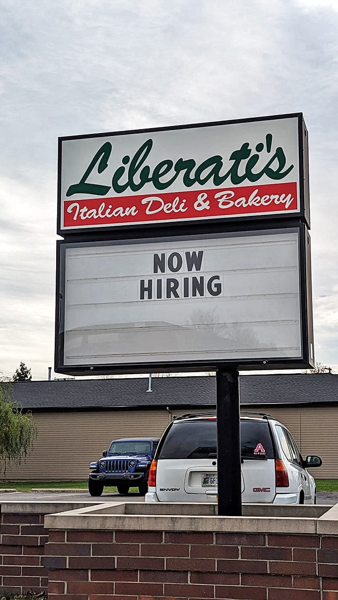 That sign says "Now Hiring" but really it should say "Come Inside and Prepare to Become a Regular Customer for Life."