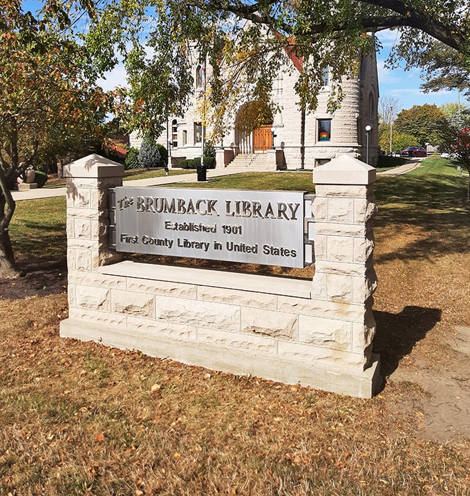 The sign proclaiming "First County Library in United States" reminds visitors they're experiencing a true pioneer in American public education.
