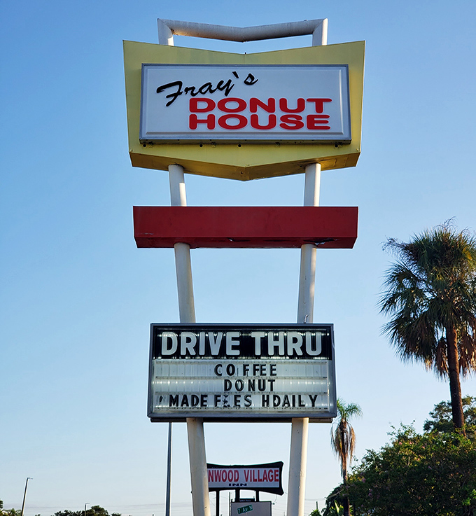 The iconic Fray's sign stands tall against blue Florida skies, a beacon of hope for those seeking handcrafted donuts in a world of mass-produced mediocrity.