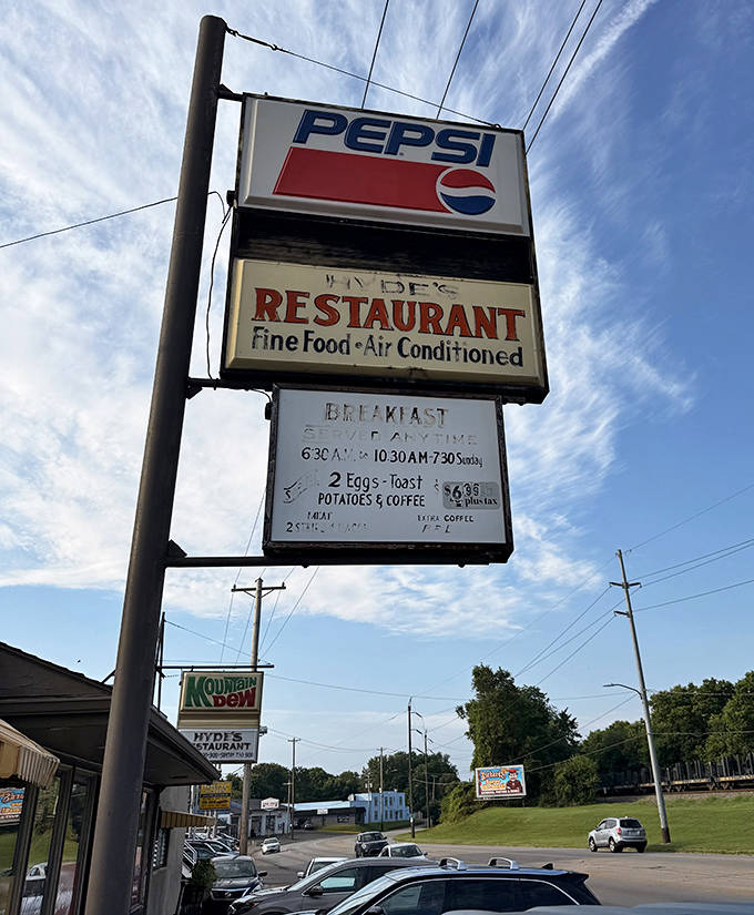 The iconic sign reaches skyward, a beacon for hungry travelers &ndash; promising "Fine Food" and the air conditioning that's just a bonus to the culinary delights within.