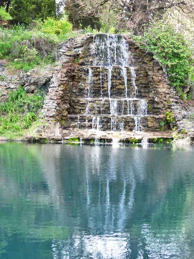 Water cascades down this artfully constructed stone wall, creating both soothing sounds and a shimmering display of liquid light.