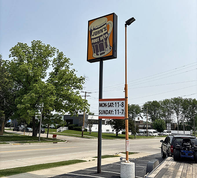 The roadside sign stands tall, a landmark for locals and a beacon for travelers seeking authentic Wisconsin refreshment without fancy frills.
