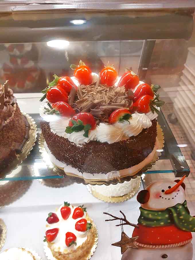 A cake that dresses for the occasion, with chocolate sponge wearing a white cream tuxedo and a crown of strawberries standing at attention around the perimeter.