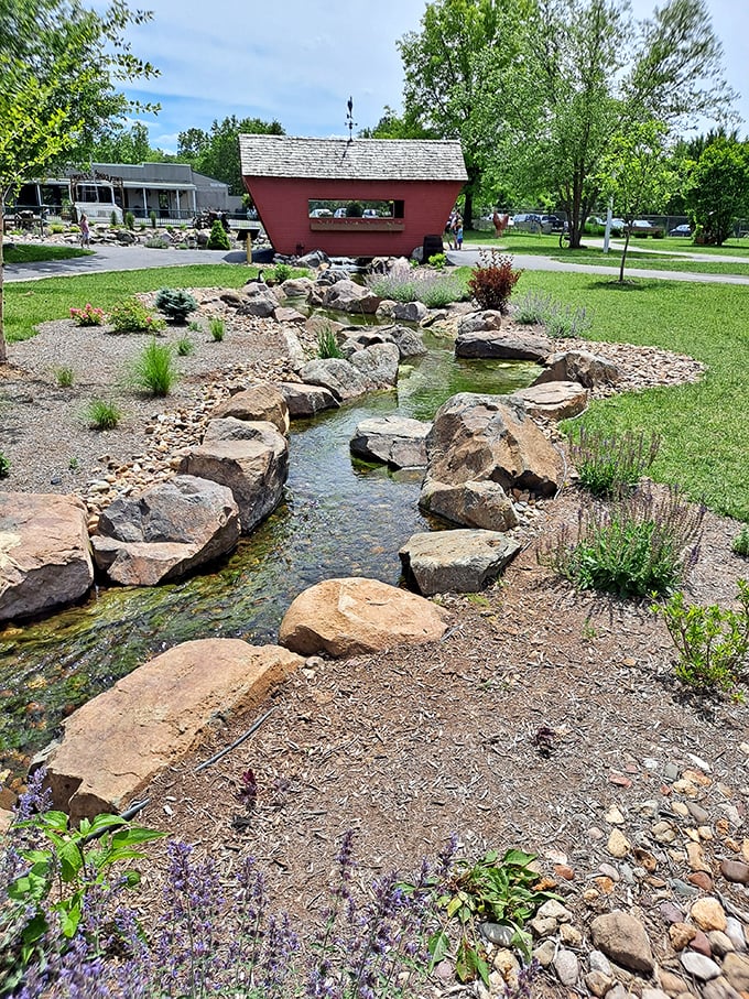 A gentle stream winds through carefully placed stones, creating a peaceful soundtrack for conversations and quiet moments.
