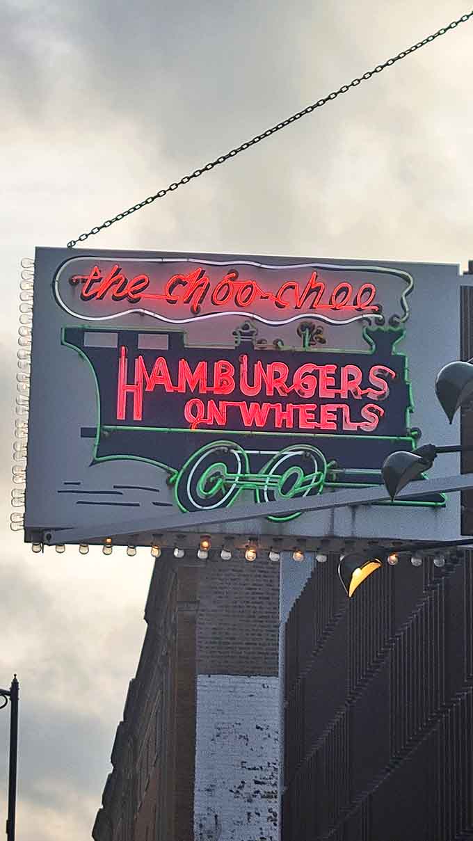 That neon sign glowing against the evening sky isn't just advertising – it's a beacon calling you home to comfort food and simpler times.