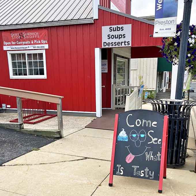 The sidewalk sign's playful face invites passersby to "Come See What Is Tasty"&mdash;a promise The Sweet Stop delivers on with every bite.