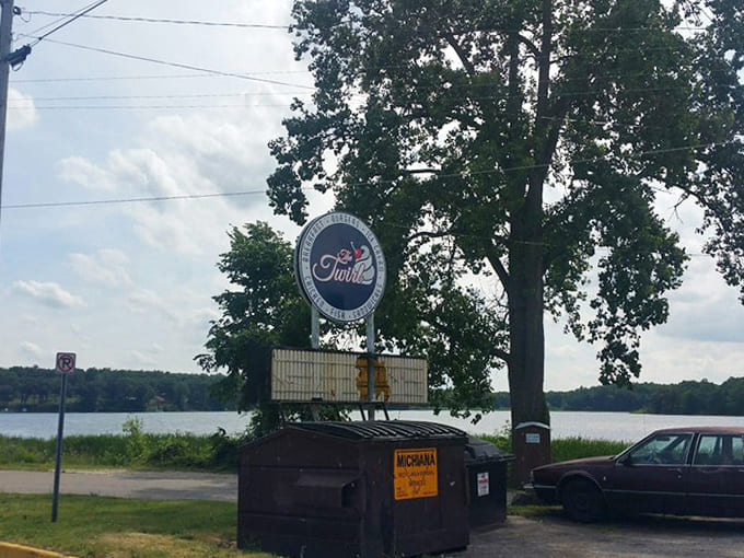 The Twirl's vintage sign stands sentinel by the lake, a landmark guiding hungry travelers to this unassuming temple of comfort food.