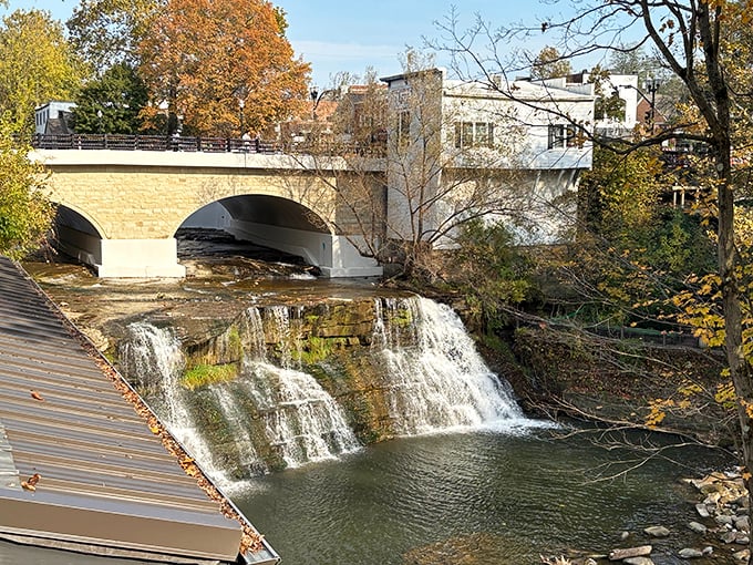 The tiered waterfall creates nature's staircase beneath a graceful bridge &ndash; architecture and landscape in perfect conversation with each other.