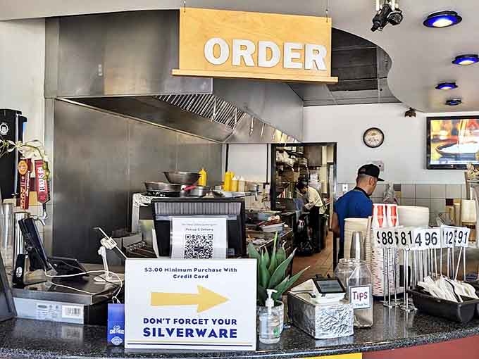 The order station where breakfast dreams become reality, complete with a reminder about silverware because we all need those sometimes.