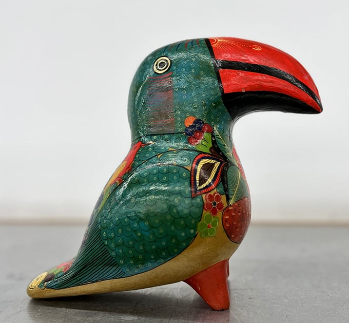 That hand-painted toucan figurine is the conversation piece your boring bookshelf has been desperately waiting for.