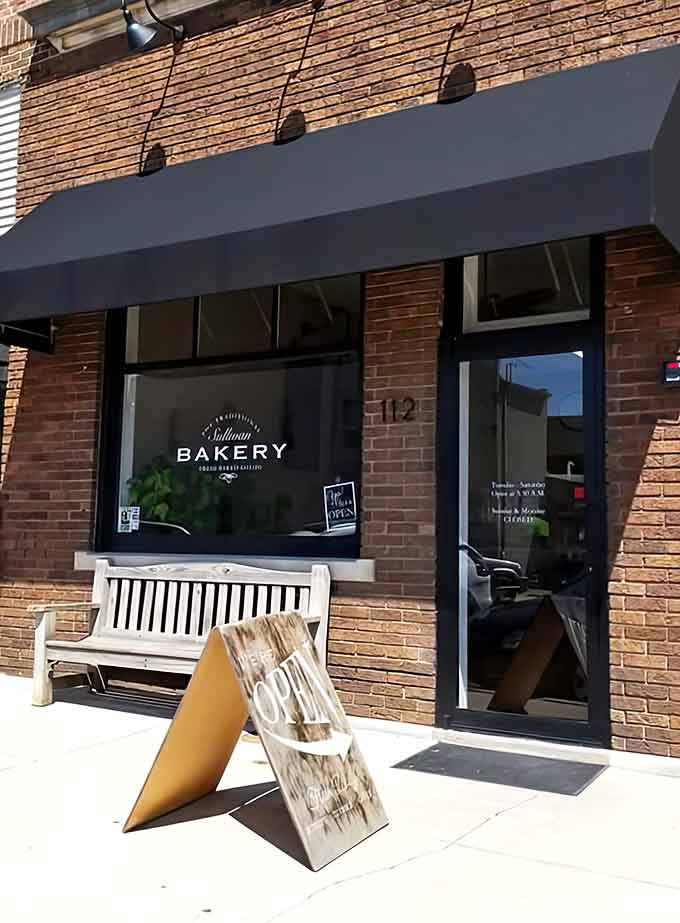 The welcoming exterior with its wooden bench invites you to sit a spell, making the transition from "just passing by" to "definitely stopping in."