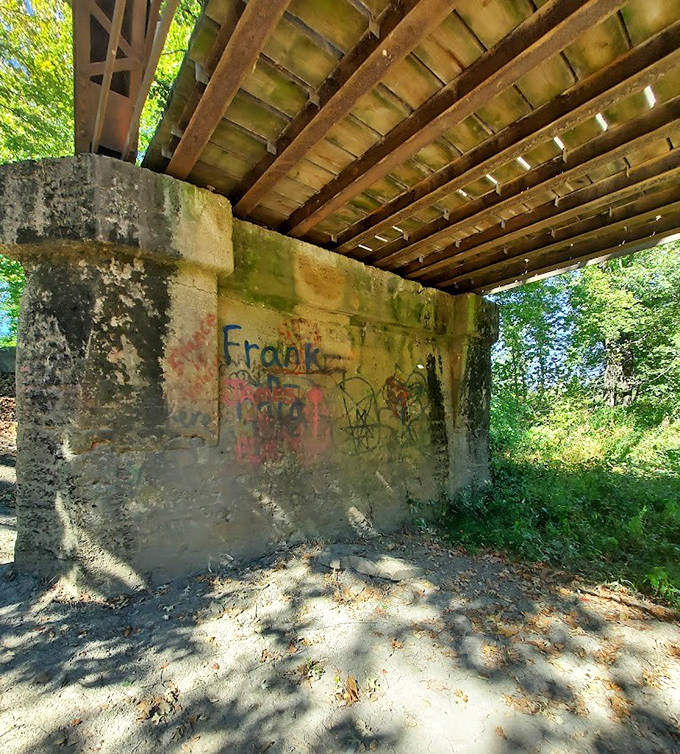 Graffiti marks the concrete supports, silent testimony to decades of visitors leaving their mark on this historic site.
