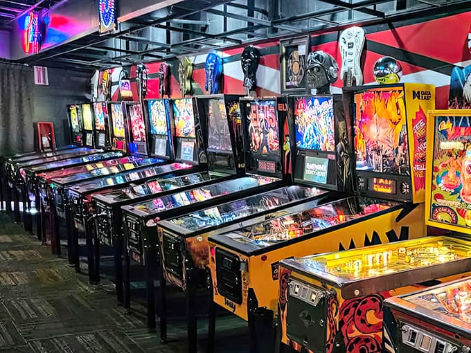 A row of pristine pinball machines stands at attention, their backglasses telling visual stories as compelling as the gameplay below.