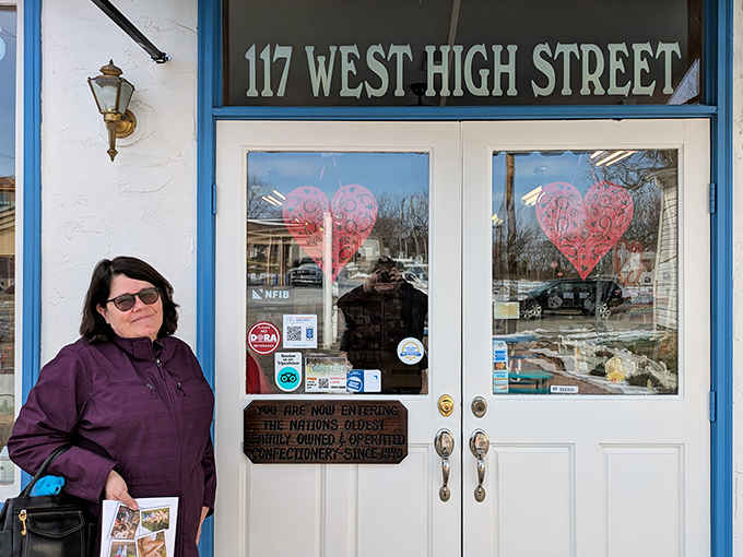 A visitor stands proudly at the entrance to Wittich's, about to embark on a journey through confectionery history that's been delighting sweet tooths since 1840.