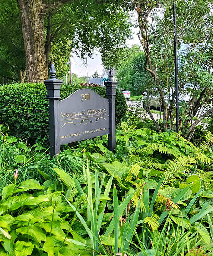 Nestled among ferns and hostas, this elegant sign welcomes visitors to an experience that transcends ordinary bed and breakfast stays.