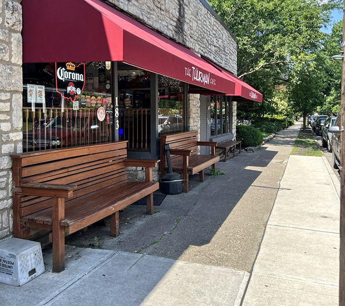 Sunlight bathes the exterior, highlighting the welcoming red awning that has beckoned hungry patrons for generations.