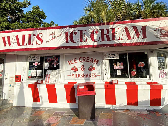 The classic storefront with its bold "ICE CREAM - MILKSHAKES" signage stands as a beacon of sweet relief in Miami's perpetual summer.