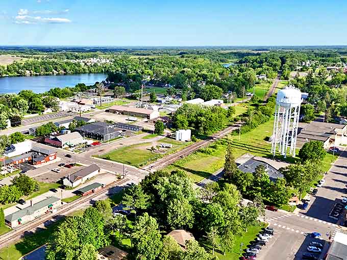 A bird's-eye view reveals Pine City's perfect balance of natural beauty and small-town charm, nestled alongside sparkling waters.