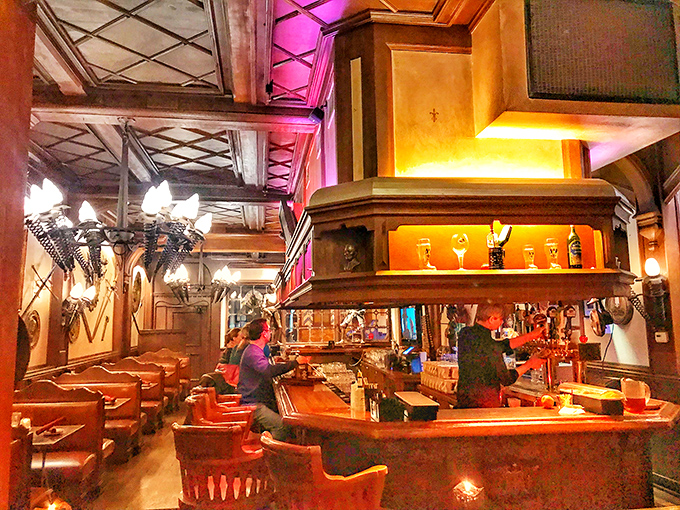 The bar area glows with warmth, offering a cozy spot to sample German beers while soaking in the Old World atmosphere.
