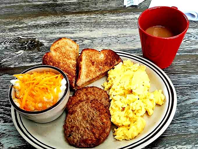Breakfast perfection on a plate &ndash; golden toast, fluffy eggs, and a sausage patty that means business. Simple pleasures executed flawlessly.