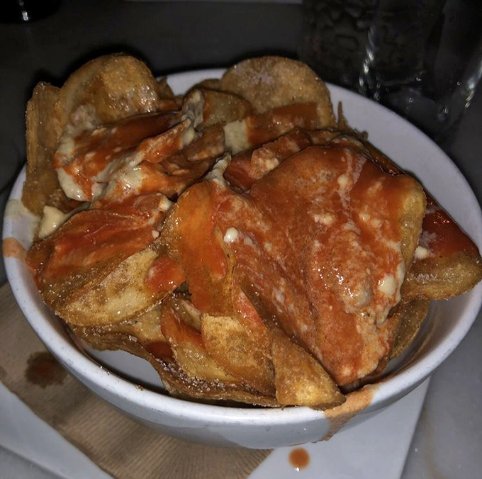 House-made potato crisps with blue cheese sauce – not just stomach-lining sustenance but a perfect complement to your cocktail journey.