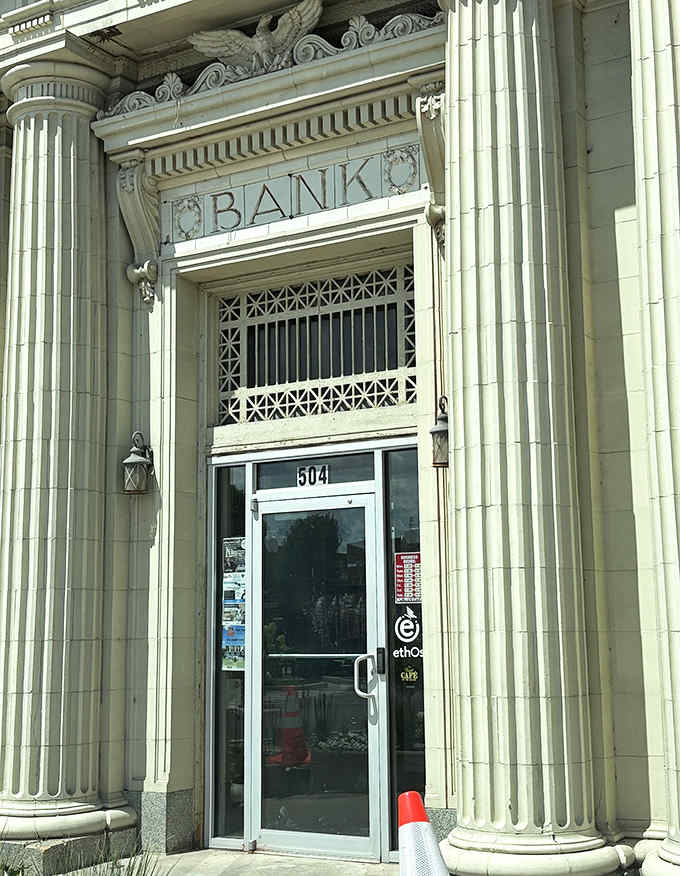 The original bank entrance, complete with "BANK" etched in stone, now welcomes diners instead of depositors. Talk about a delicious transformation!