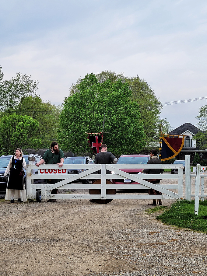 Period-costumed interpreters guard the entrance, transporting visitors across the threshold between modern life and historical immersion.