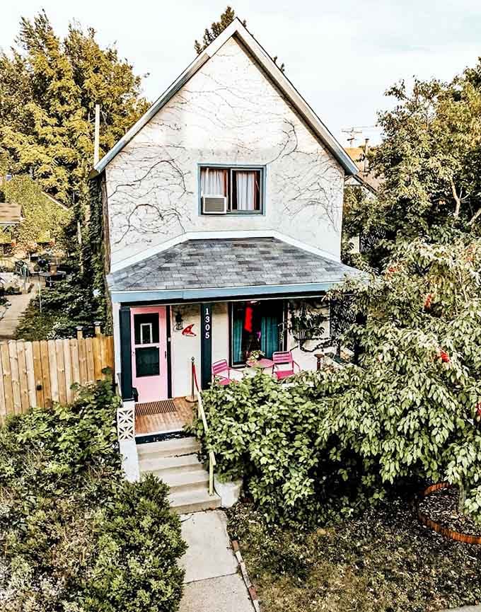 The exterior might whisper "charming cottage," but those pink porch chairs are giving away the secret &ndash; normal stops at the front door of this Minneapolis gem.