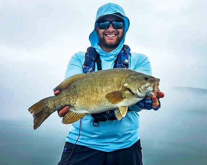 Angler's triumph: A proud fisherman displays his impressive Hubbard Lake catch, proof that sometimes the big one doesn't always get away.