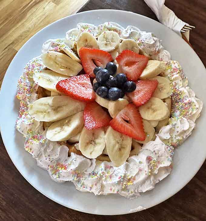 This fruit-adorned pancake isn't just breakfast&mdash;it's a celebration on a plate, with fresh berries arranged like edible confetti.