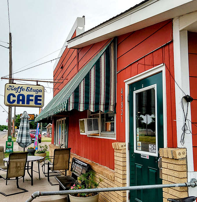 The striped awning and green door welcome visitors like old friends, promising that inside, time moves a little slower and food tastes a little better.