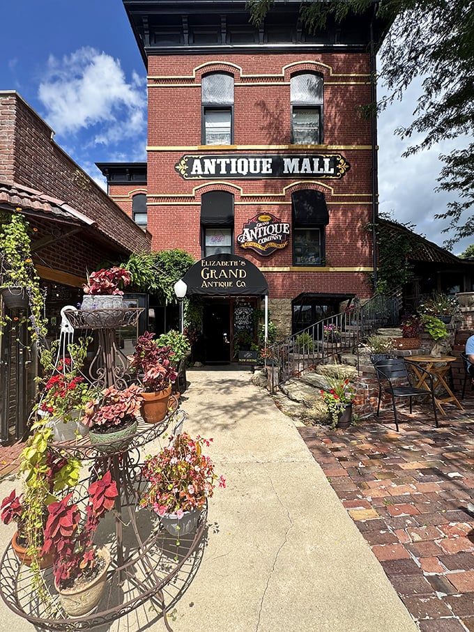 Elizabeth's Grand Antique Co. announces itself with vintage confidence, its welcoming entrance framed by seasonal flowers and historic stonework.