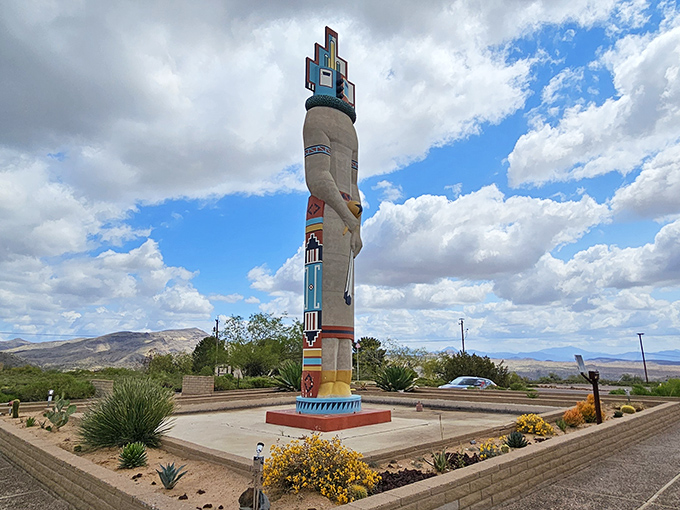 Framed by mountains and sky, the Corn Maiden Dancer Kachina represents purification in Hopi tradition.